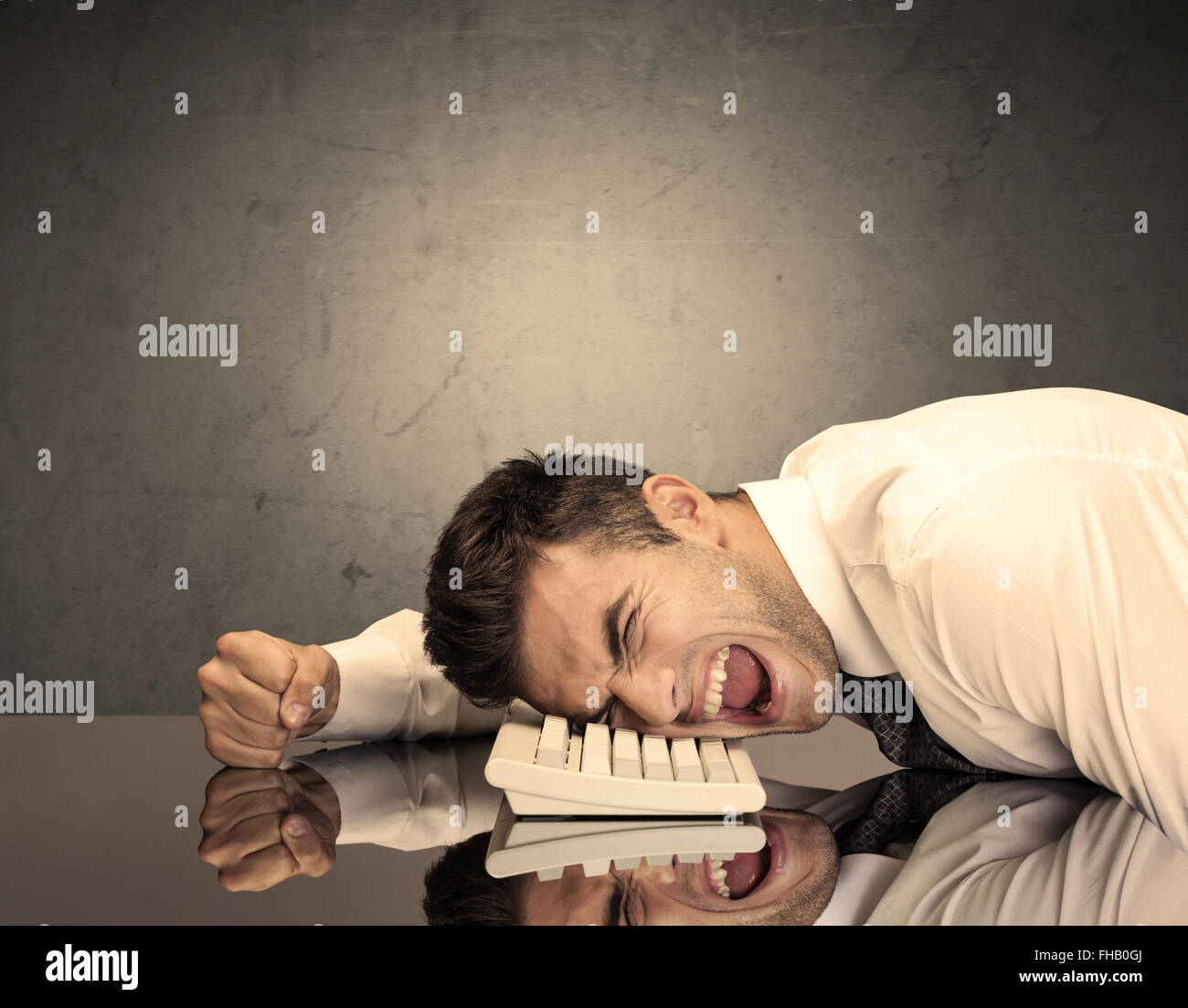 Frustrated businessman's head on keyboard Stock Photo - Alamy