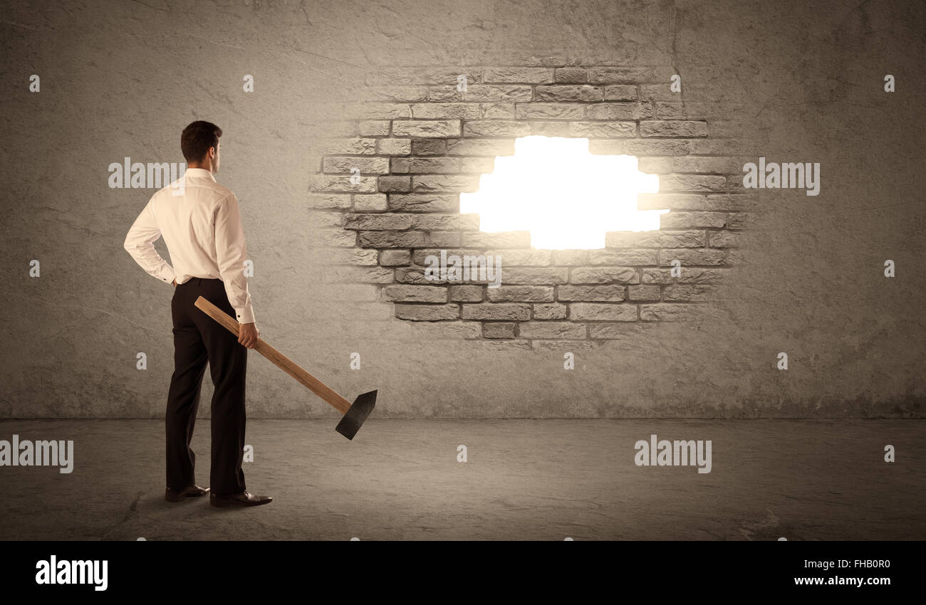 Business man hitting brick wall with hammer and opening a hole Stock ...