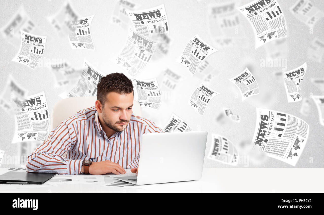 Business man at desk with stock market newspapers Stock Photo - Alamy