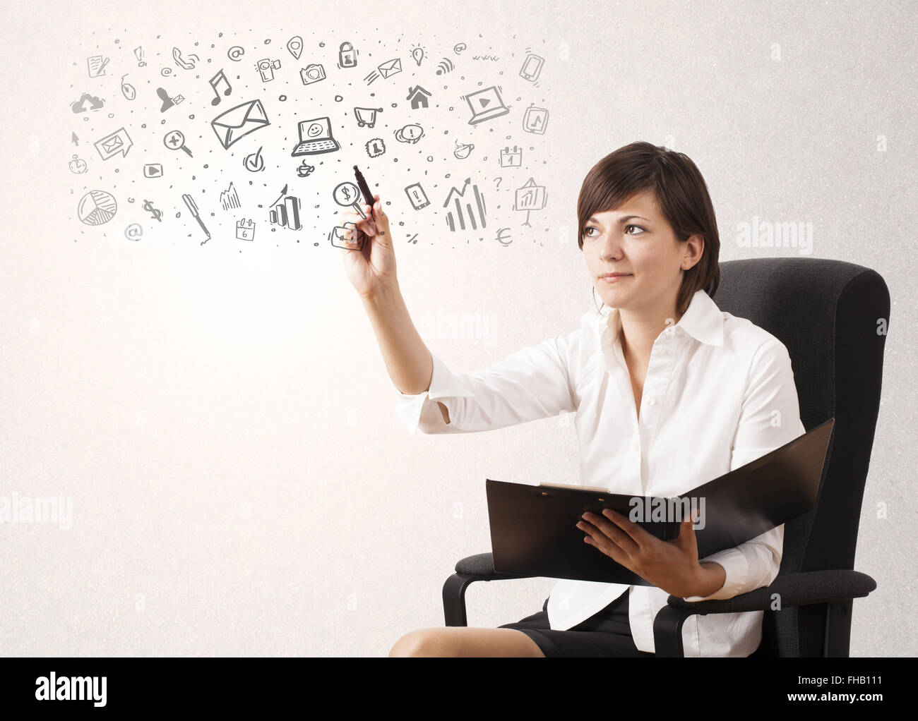 Young woman drawing and sketching icons and symbols Stock Photo - Alamy