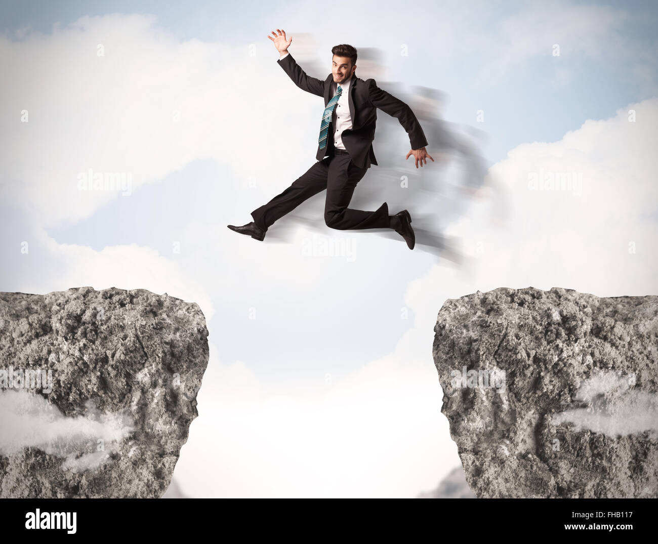 Funny business man jumping over rocks with gap Stock Photo - Alamy