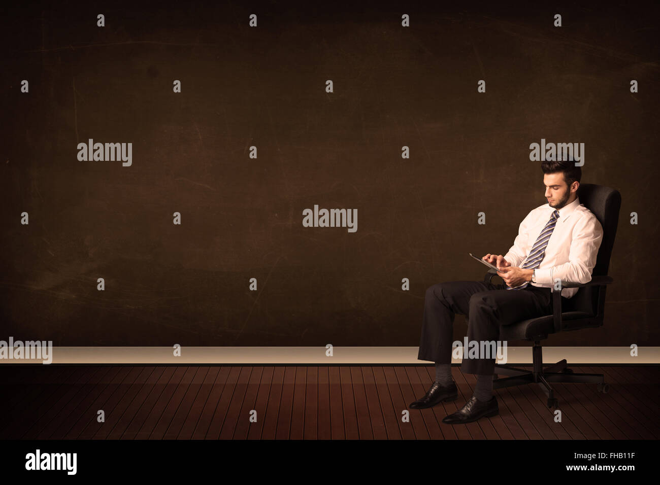 Businessman holding high tech tablet on background with copyspace Stock ...