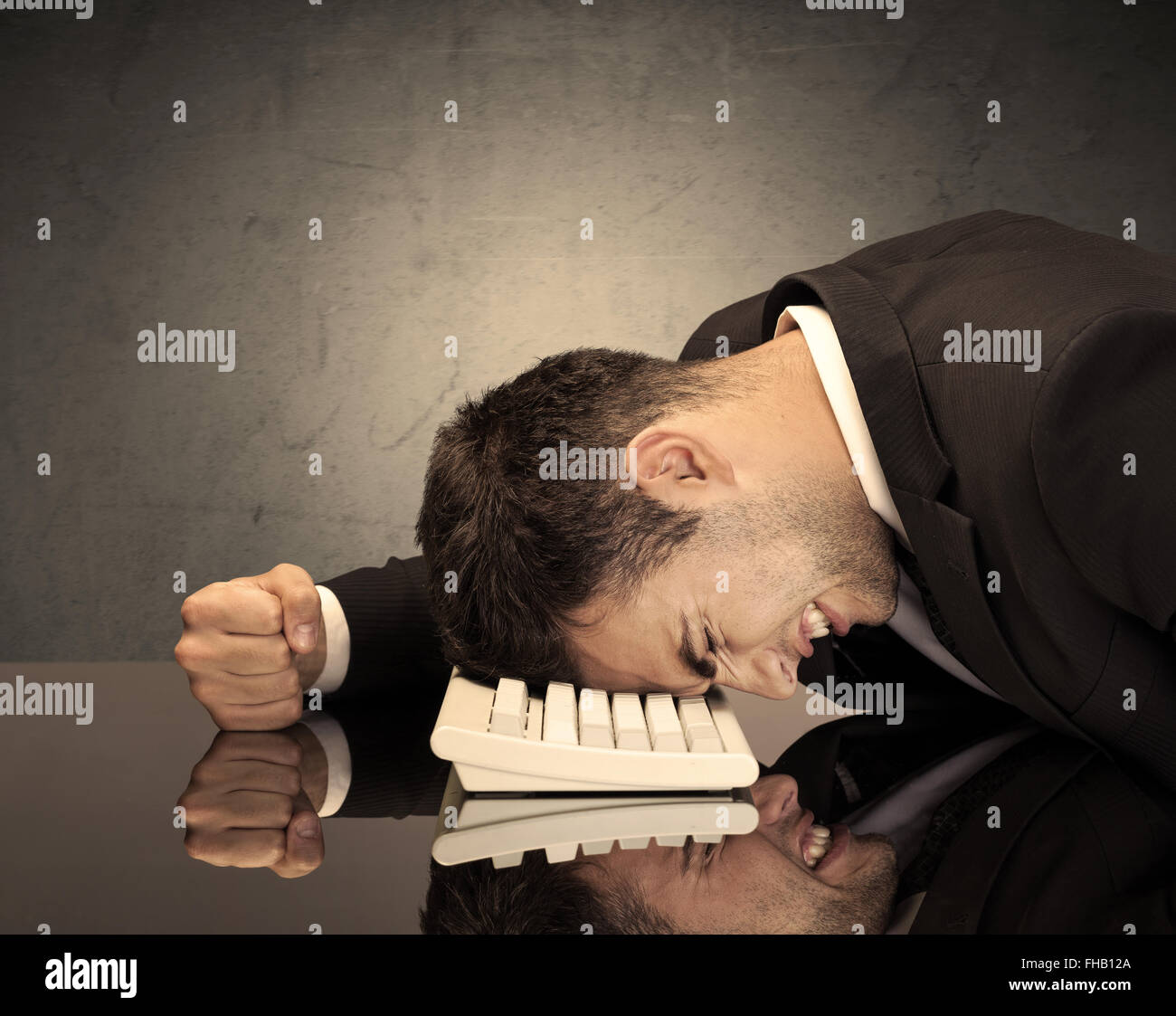 Frustrated businessman's head on keyboard Stock Photo - Alamy