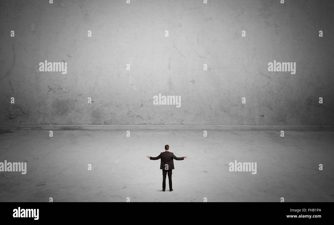 Small business person in large empty space Stock Photo - Alamy