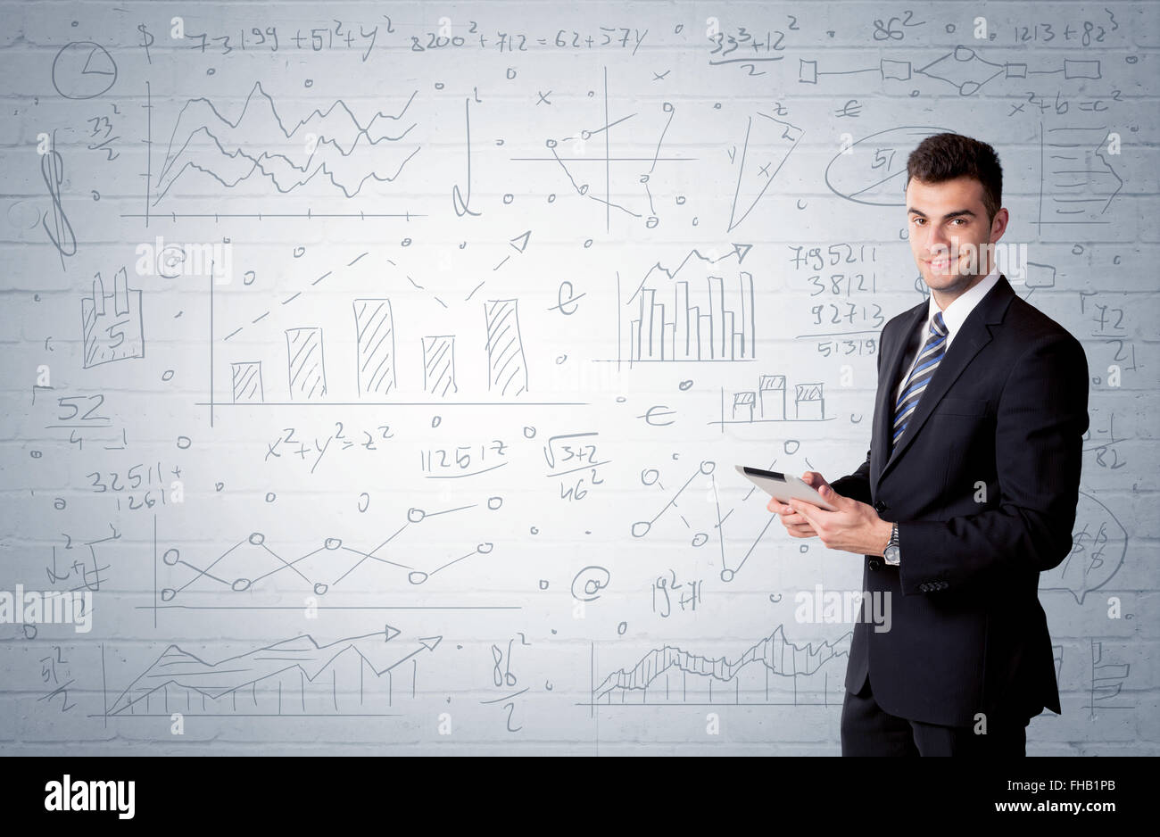 Salesman standing with drawn graph charts Stock Photo - Alamy