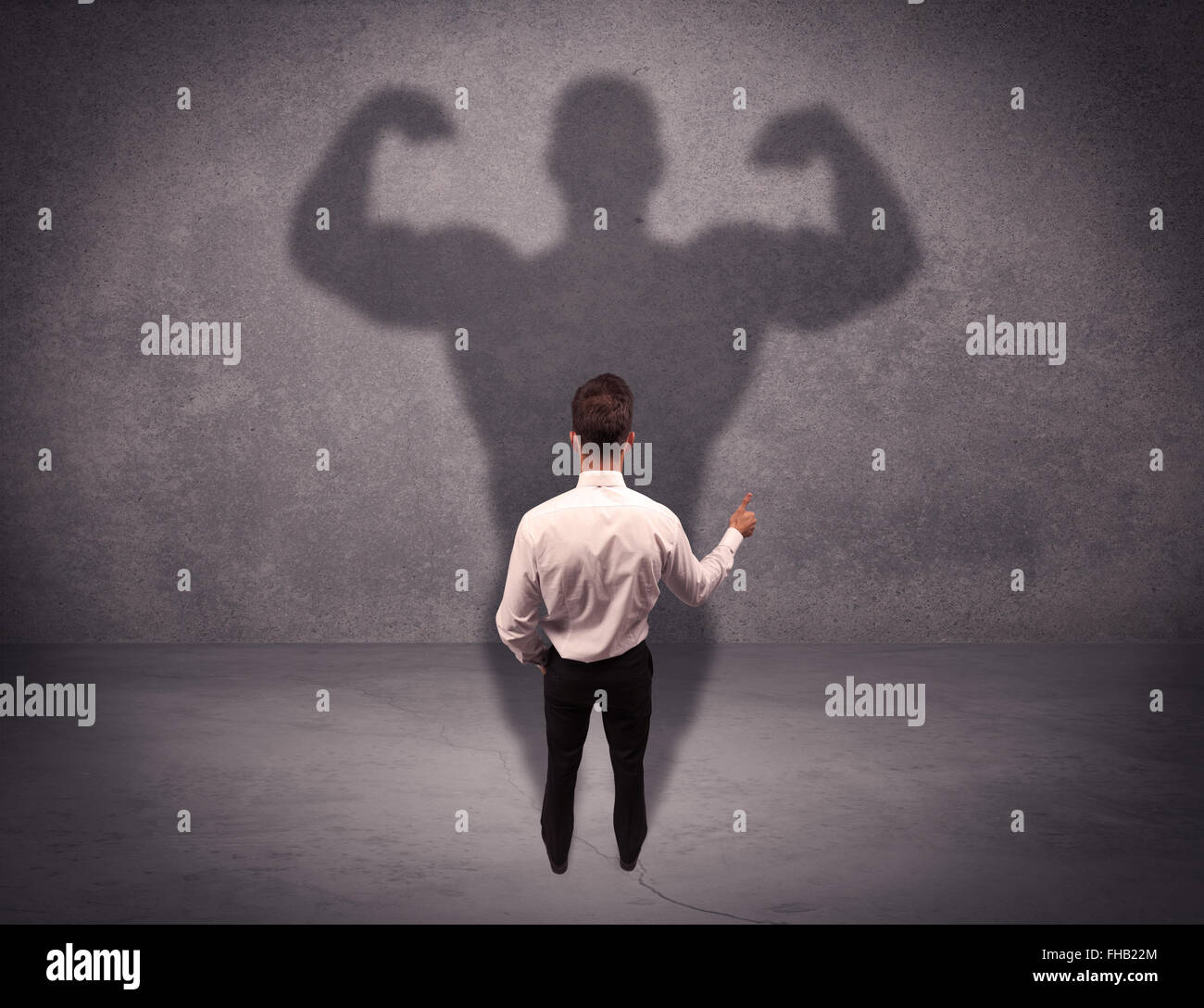 Successful businessman with strong shadow Stock Photo - Alamy