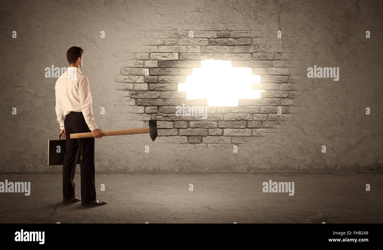 Business man hitting brick wall with hammer and opening a hole Stock ...