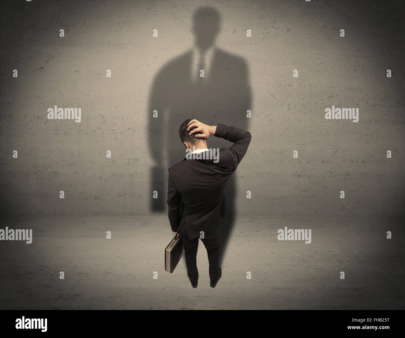 Businessman looking at big shadow concept Stock Photo - Alamy