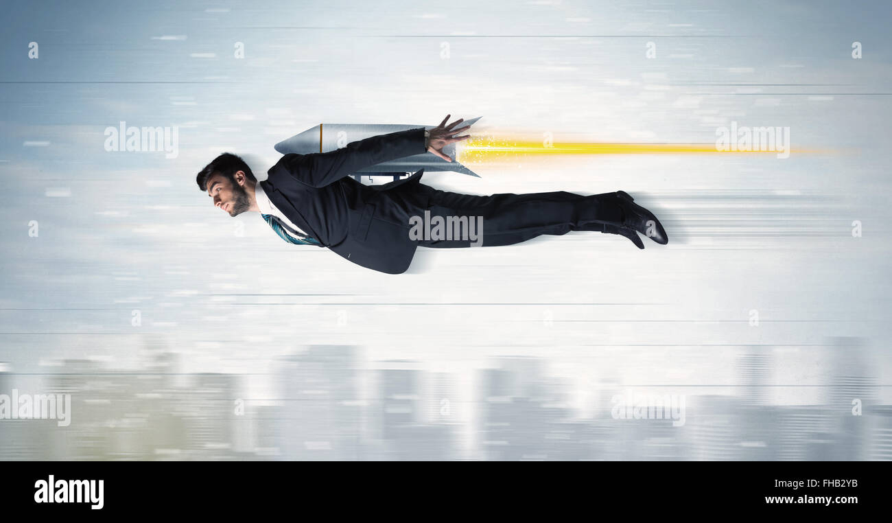 Superhero business man flying with jet pack rocket above the city Stock ...