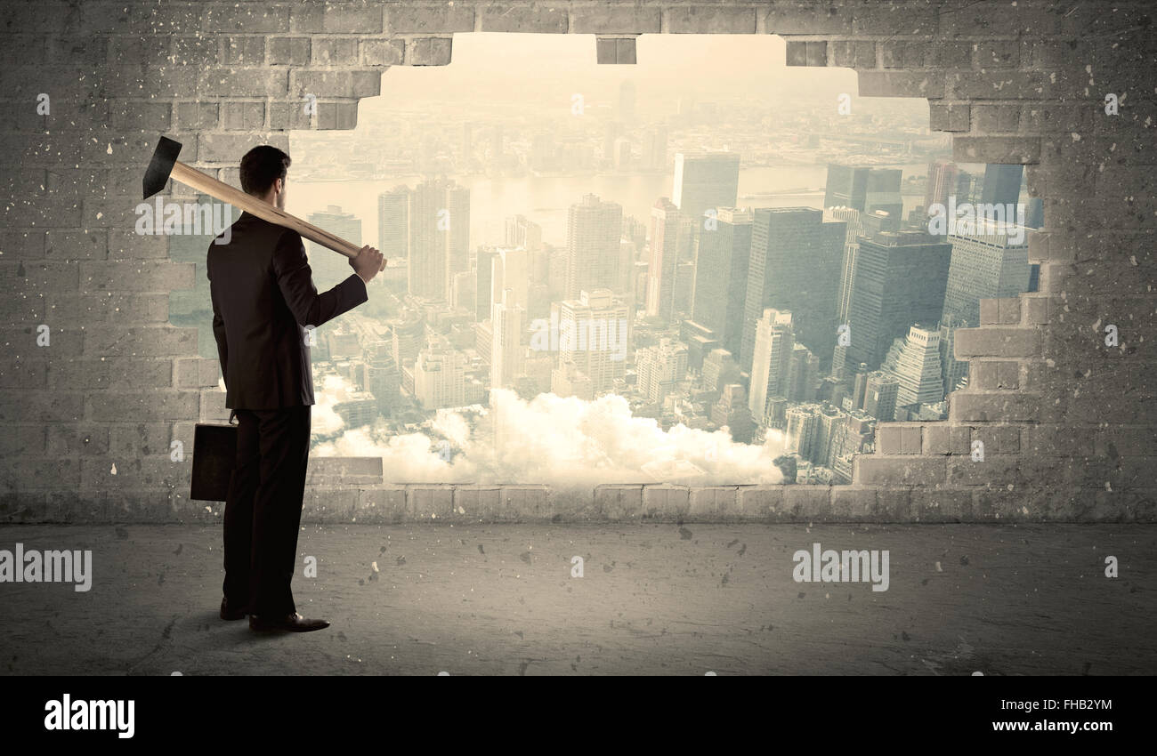 Business man hitting wall with hammer on city view Stock Photo - Alamy