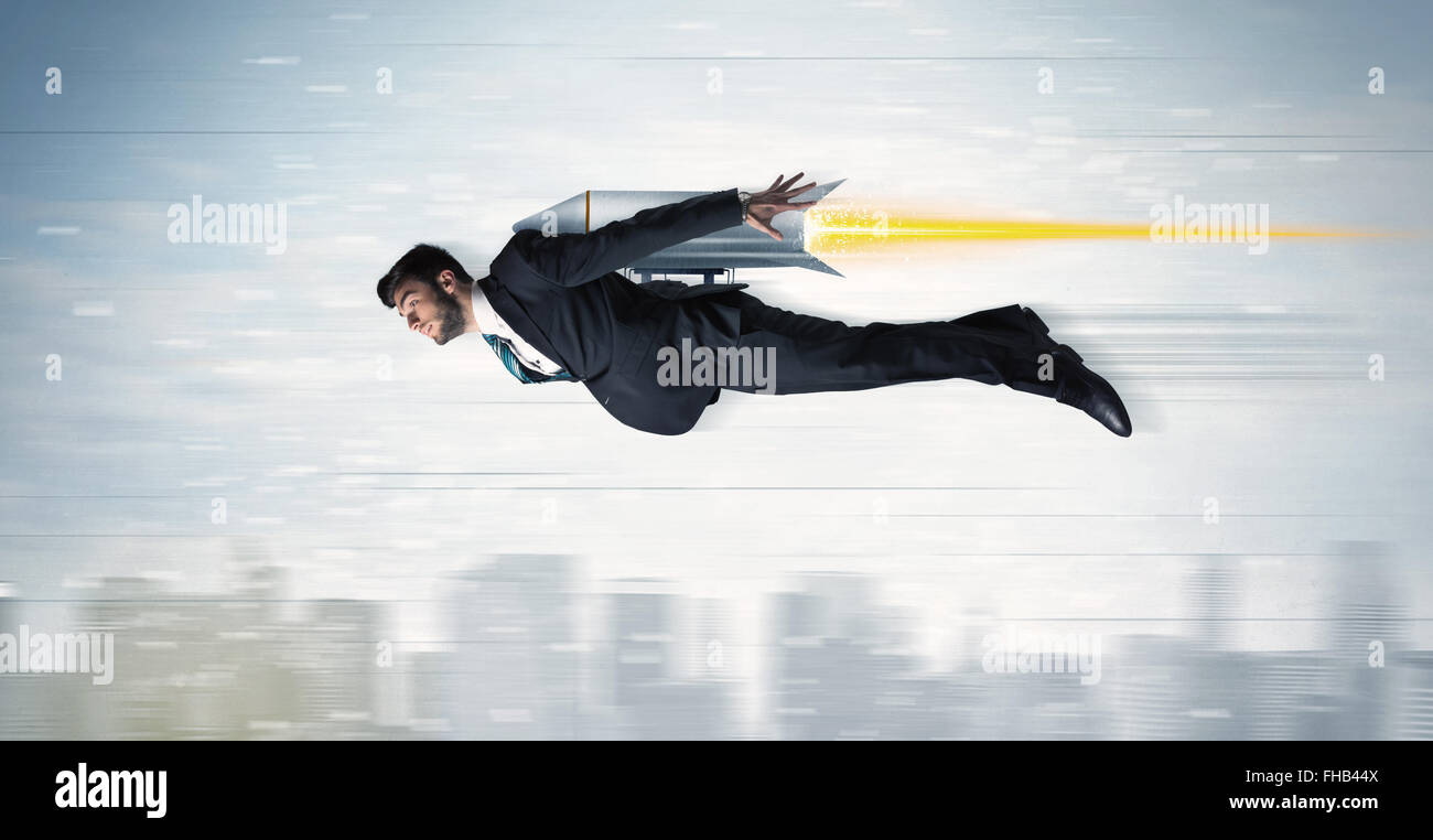 Superhero business man flying with jet pack rocket above the city Stock ...