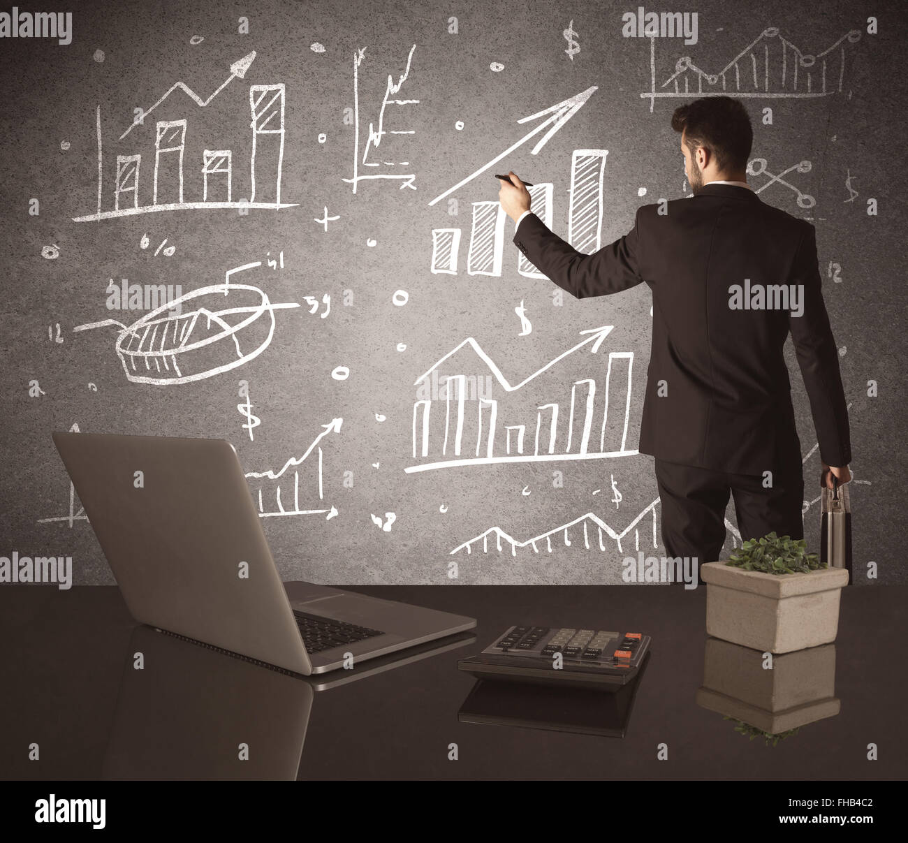Businessman drawing sales charts on wall Stock Photo - Alamy