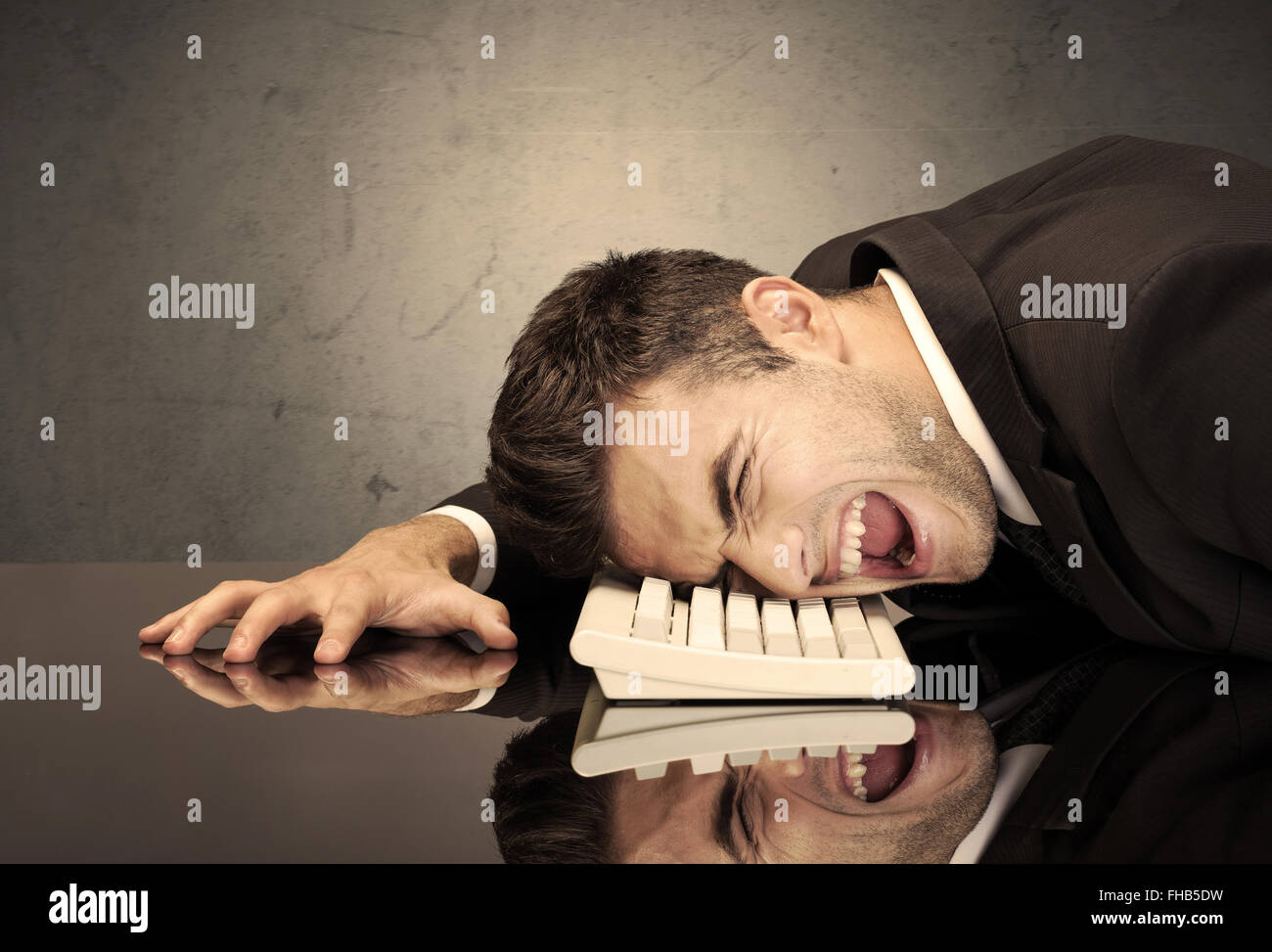 Frustrated businessman's head on keyboard Stock Photo - Alamy