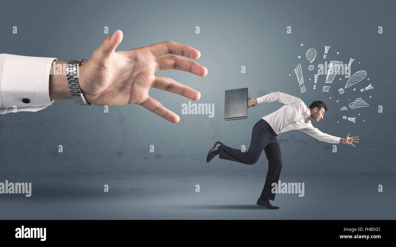 Business person getting away from a big hand Stock Photo - Alamy