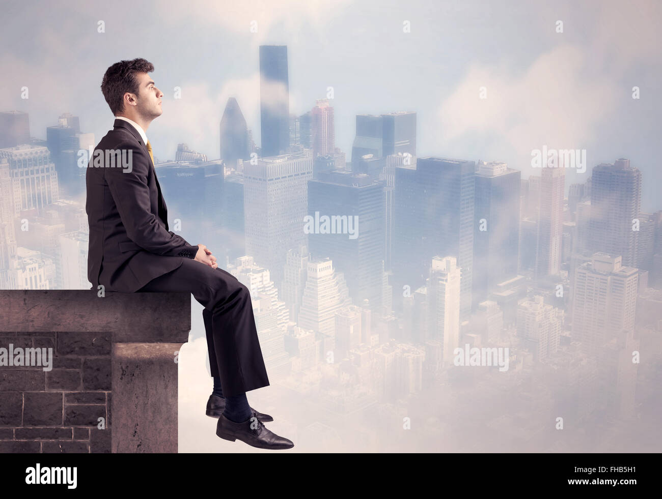 Sales person sitting on top of a tall building Stock Photo - Alamy