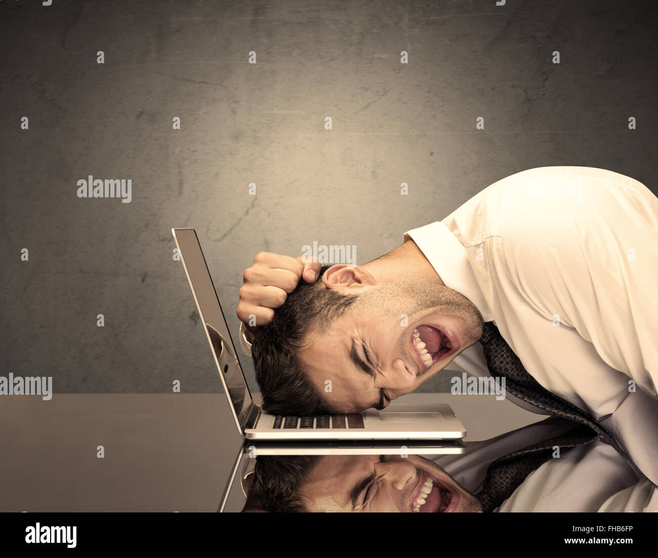 Frustrated businessman's head on keyboard Stock Photo - Alamy