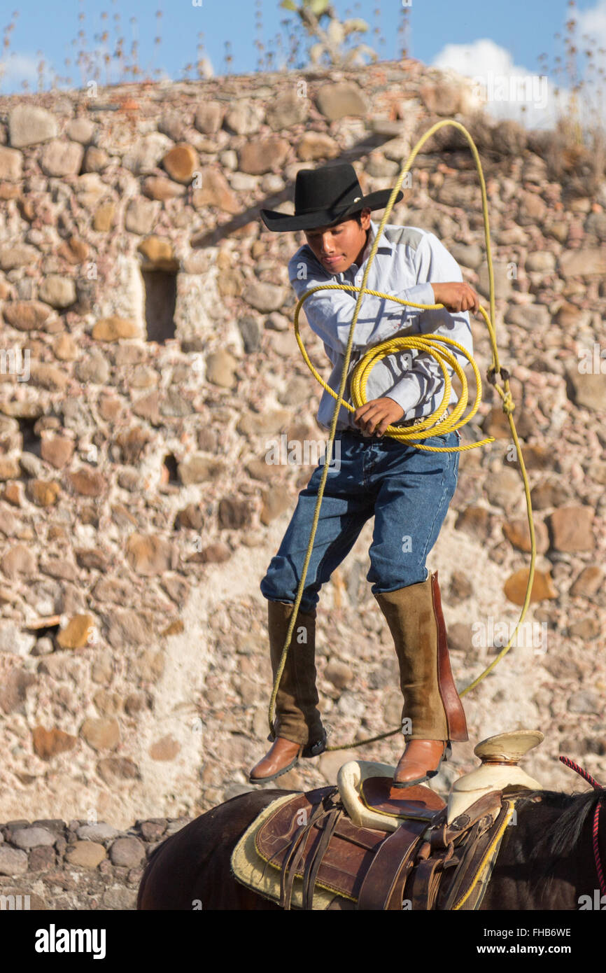 A Mexican charro or cowboy practices roping skills on his horse before ...