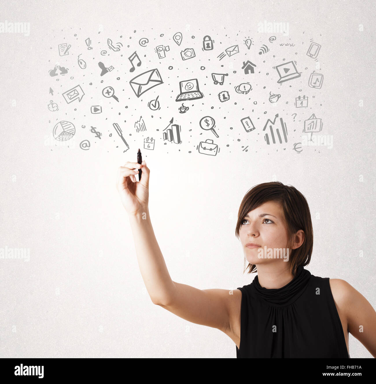 Young woman drawing and sketching icons and symbols Stock Photo - Alamy