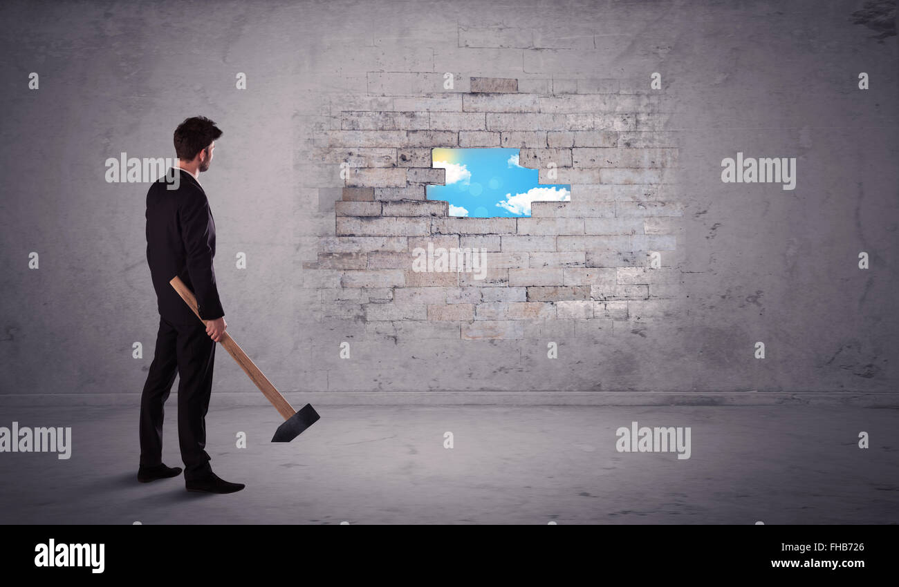 Business man hitting brick wall with hammer Stock Photo - Alamy