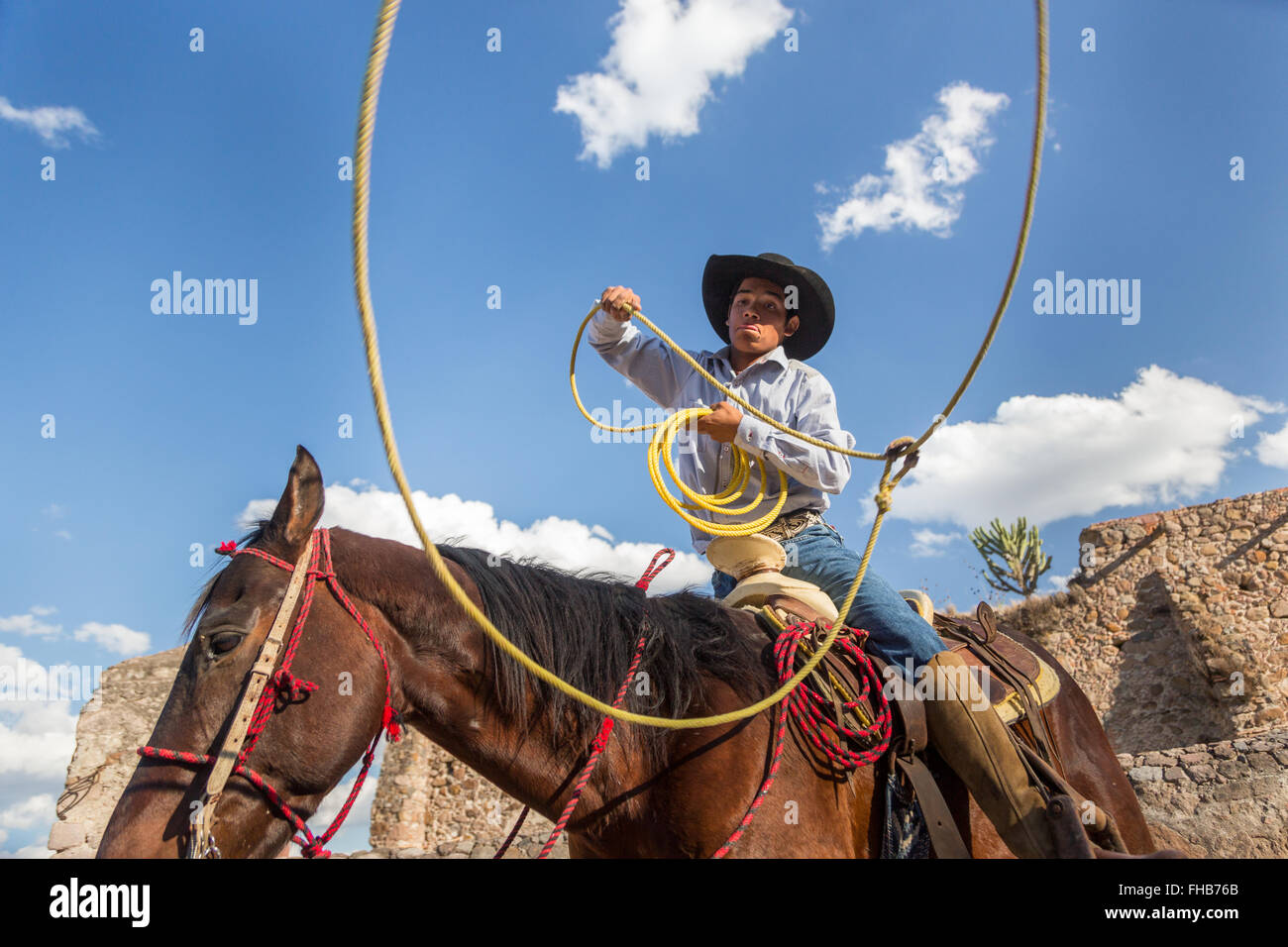 A Mexican charro or cowboy practices roping skills on his horse before ...