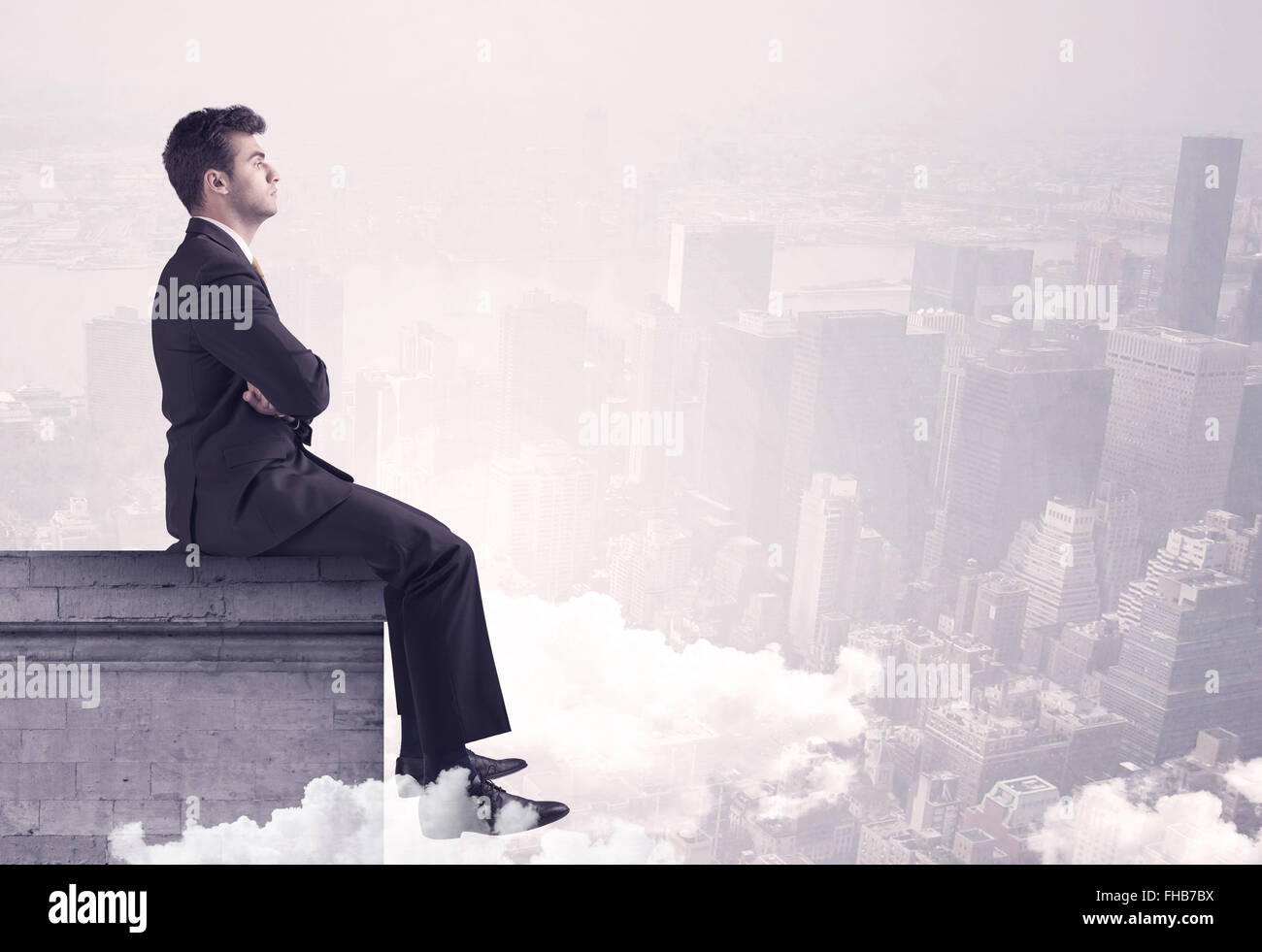 Sales person sitting on building edge in city Stock Photo - Alamy