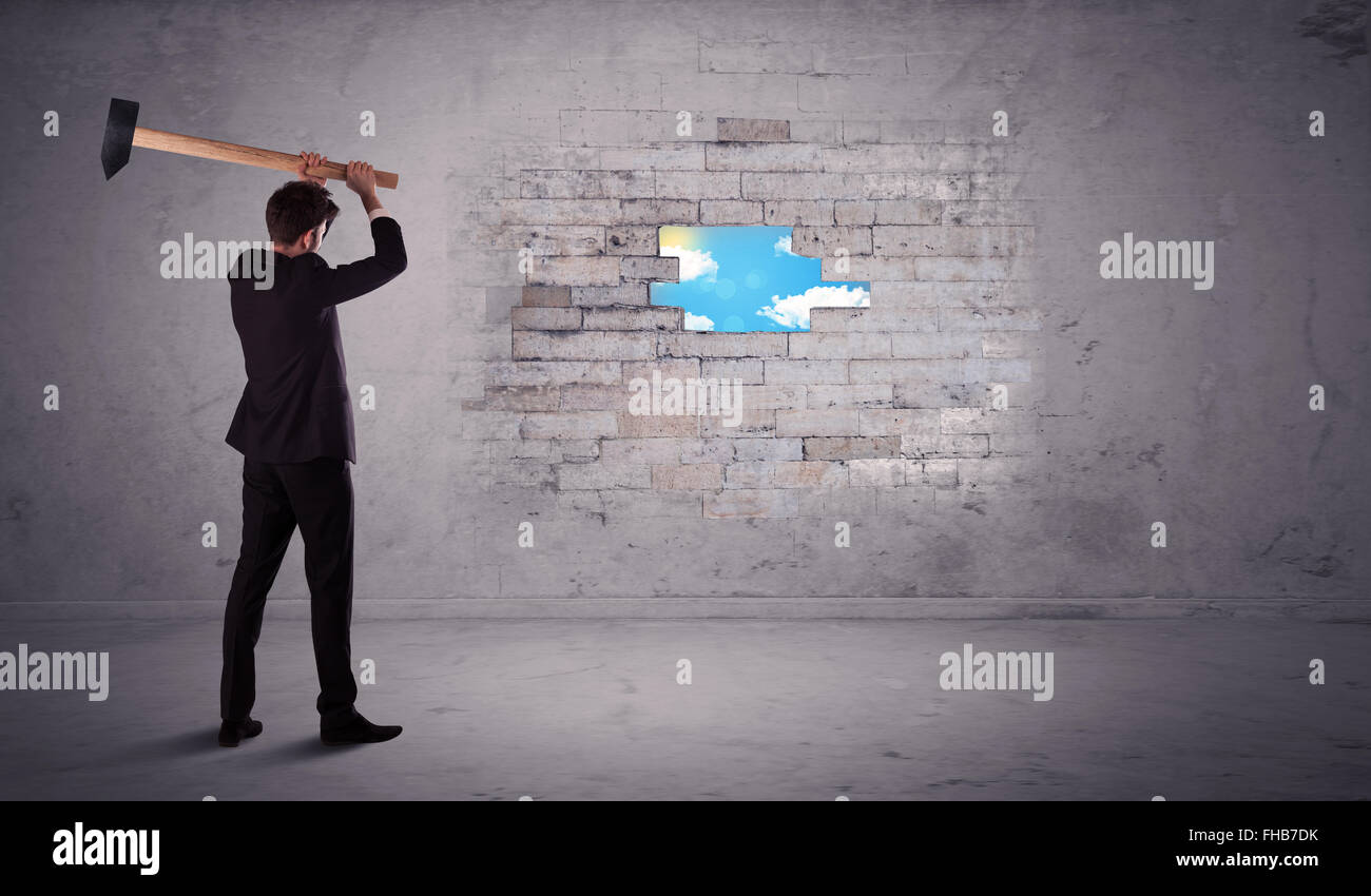 Business man hitting brick wall with hammer Stock Photo - Alamy