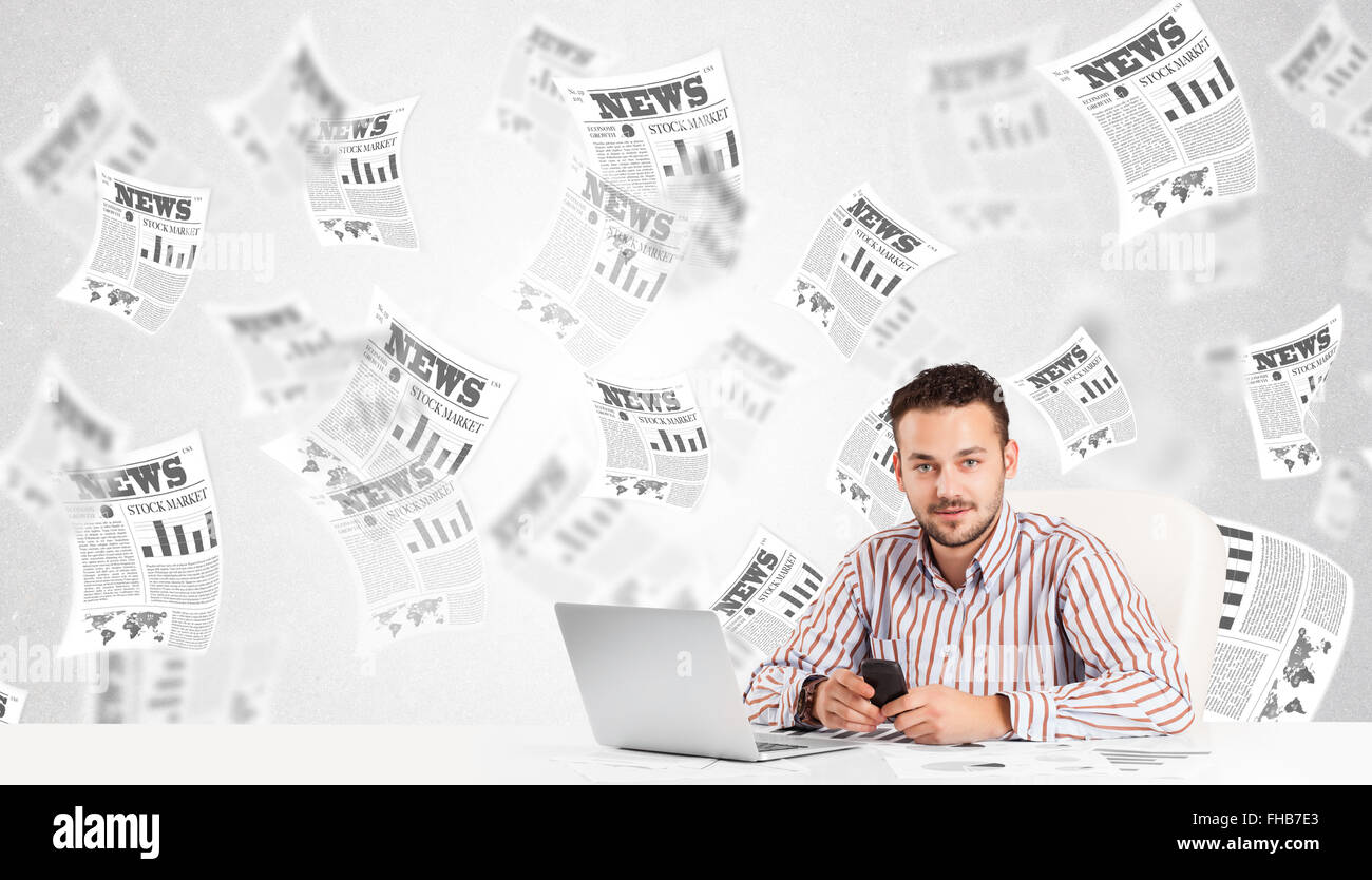 Business man at desk with stock market newspapers Stock Photo - Alamy