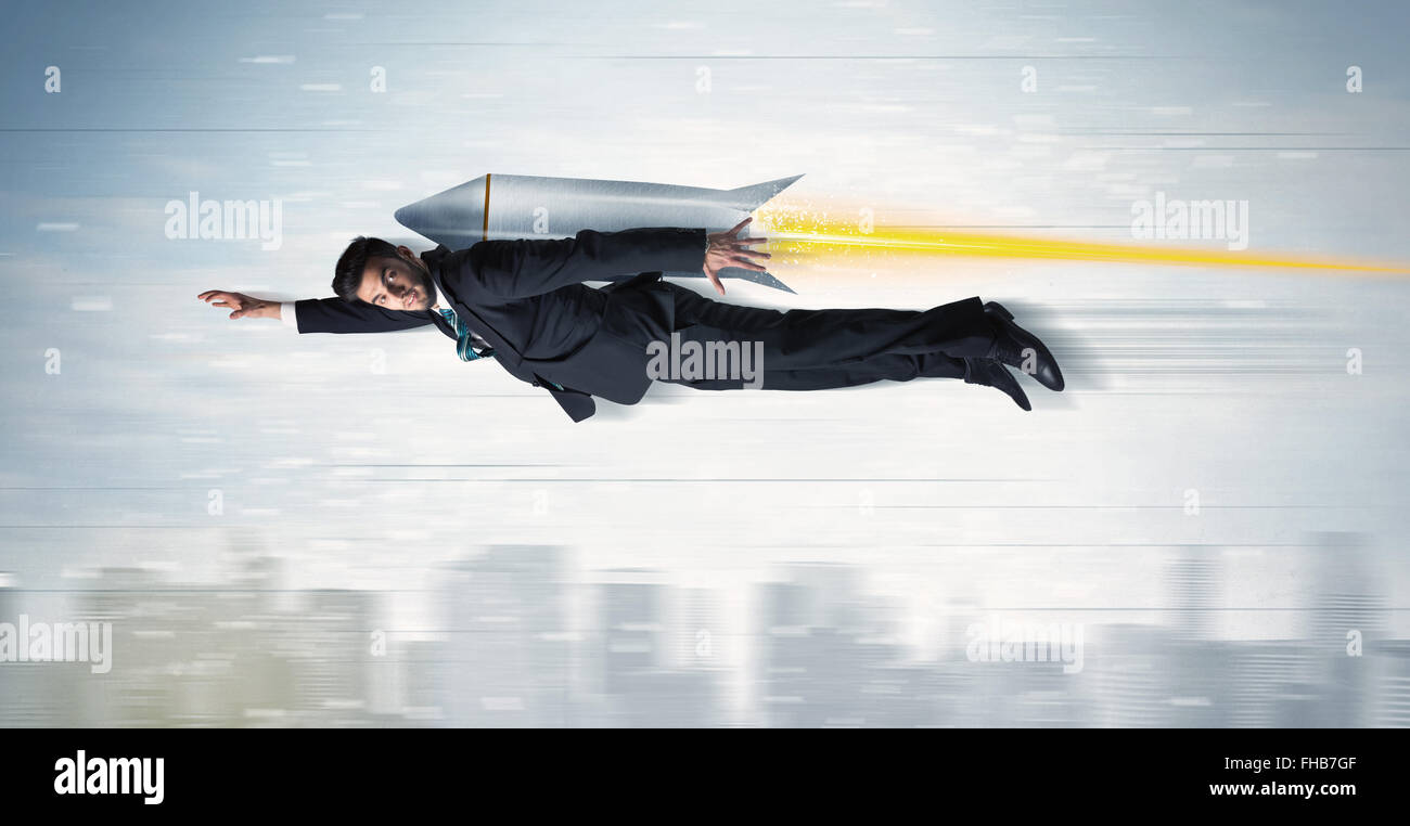 Superhero business man flying with jet pack rocket above the city Stock ...