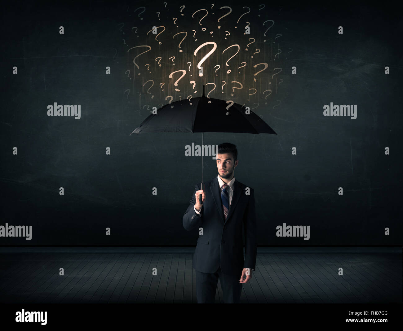 Businessman with umbrella and a lot of drawn question marks Stock Photo ...