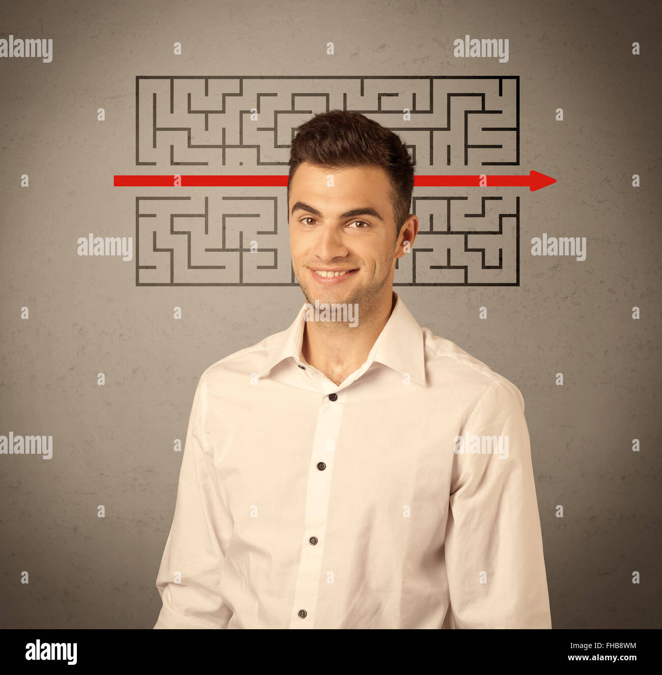 Handsome business guy solving maze Stock Photo - Alamy