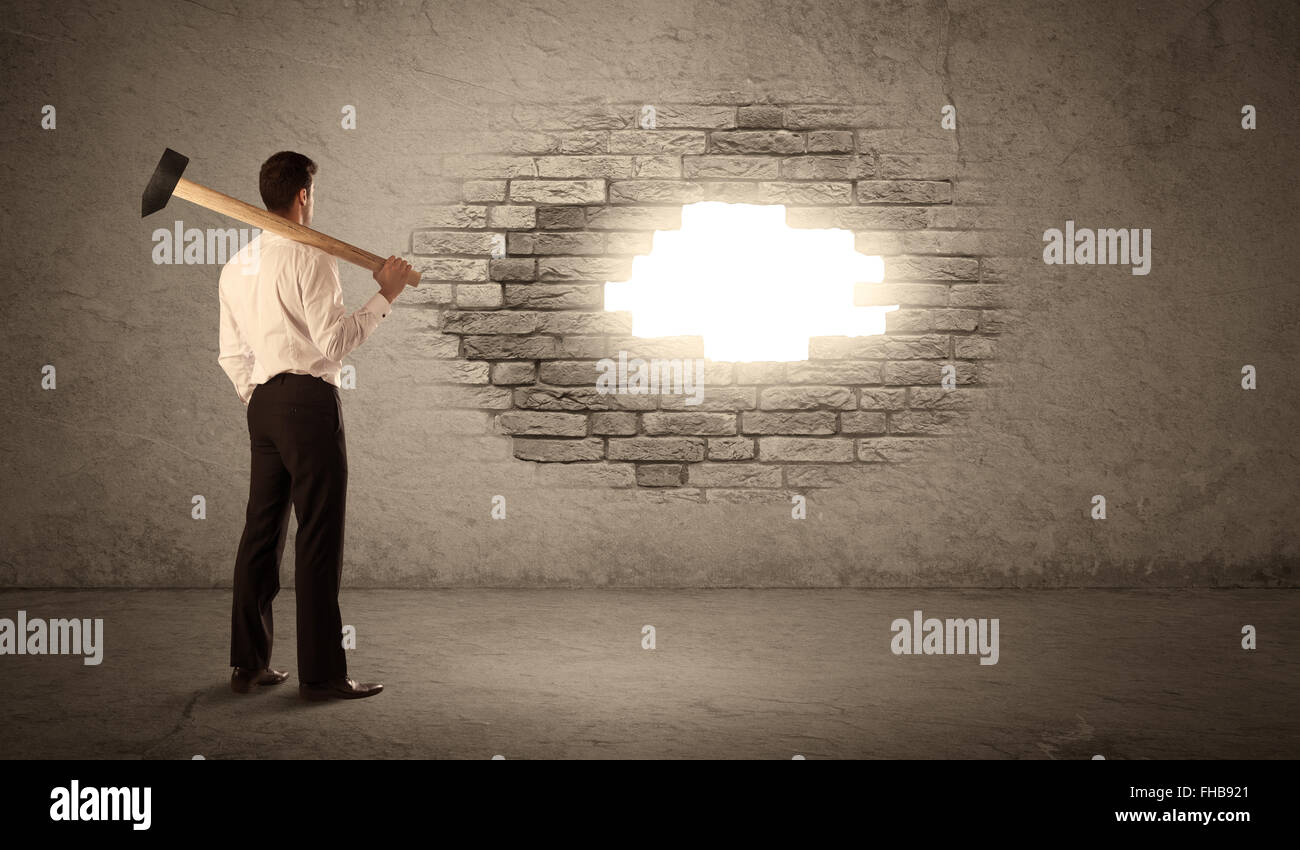Business man hitting brick wall with hammer and opening a hole Stock ...