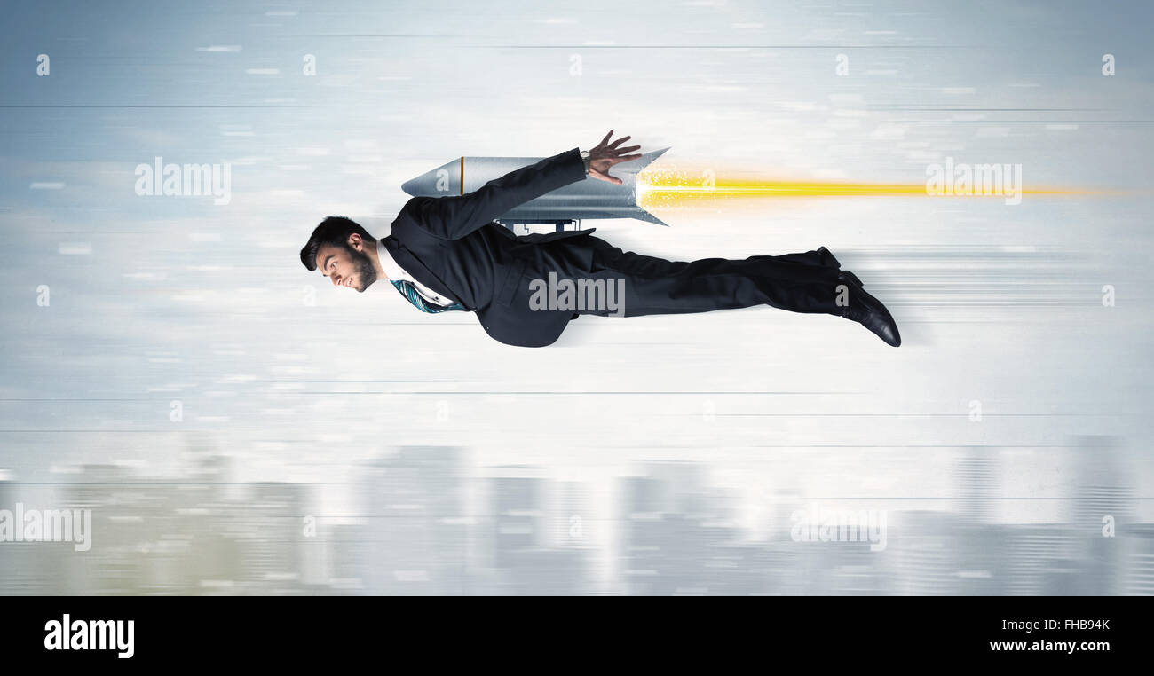 Superhero business man flying with jet pack rocket above the city Stock ...