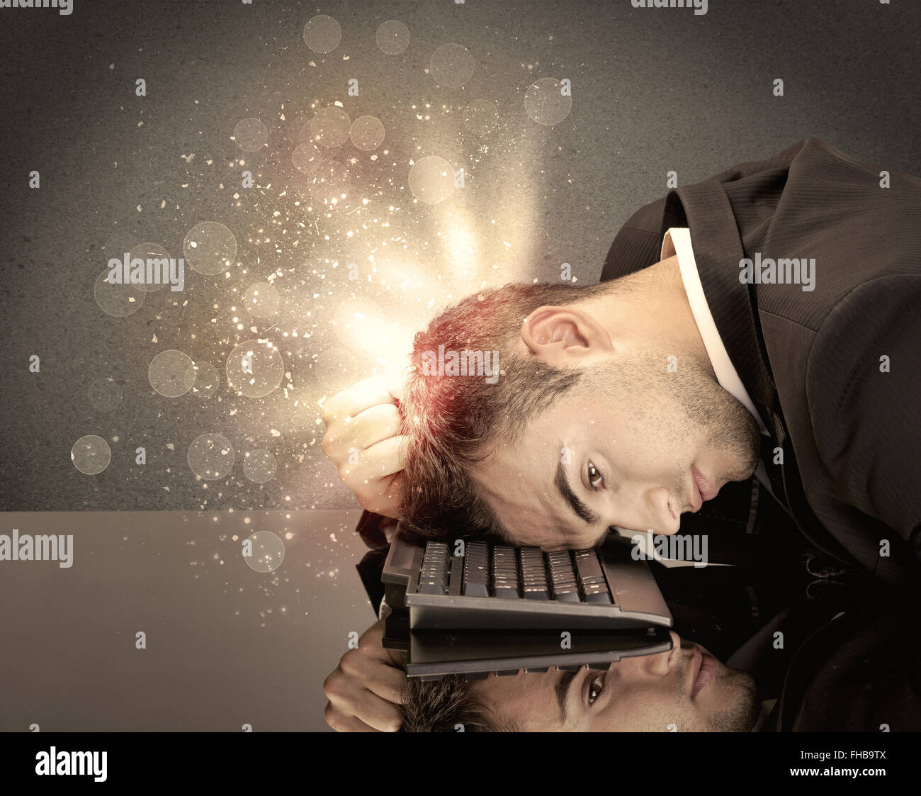 Angry businessman with lights and keyboard Stock Photo - Alamy