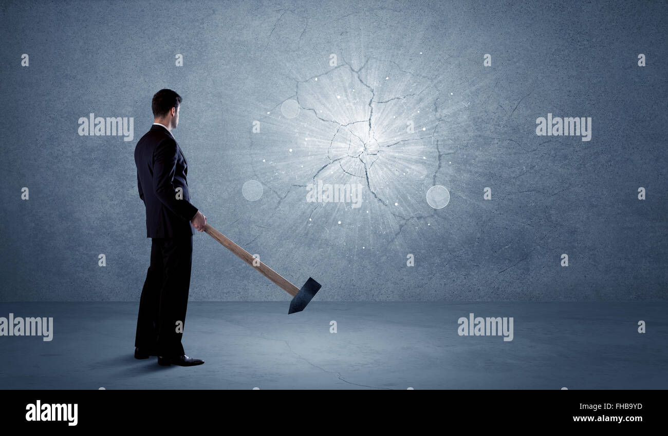 Business man hitting wall with a hammer Stock Photo - Alamy