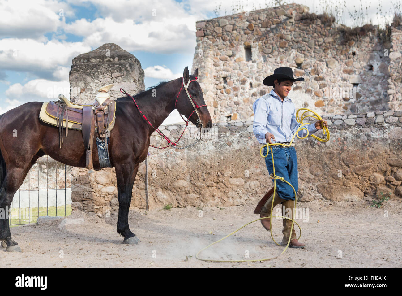 A Mexican charro or cowboy practices roping skills with his horse at a ...