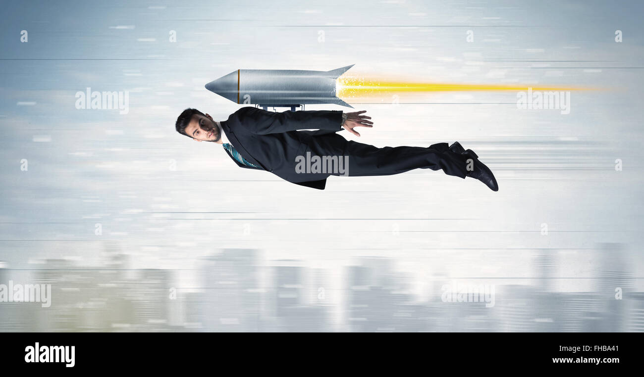 Superhero business man flying with jet pack rocket above the city Stock ...
