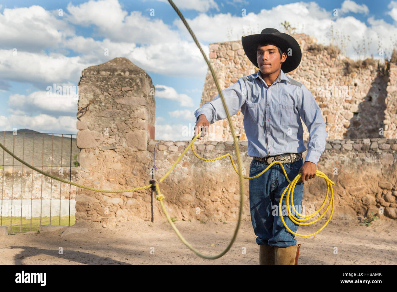 A Mexican charro or cowboy practices roping skills at a hacienda ranch ...