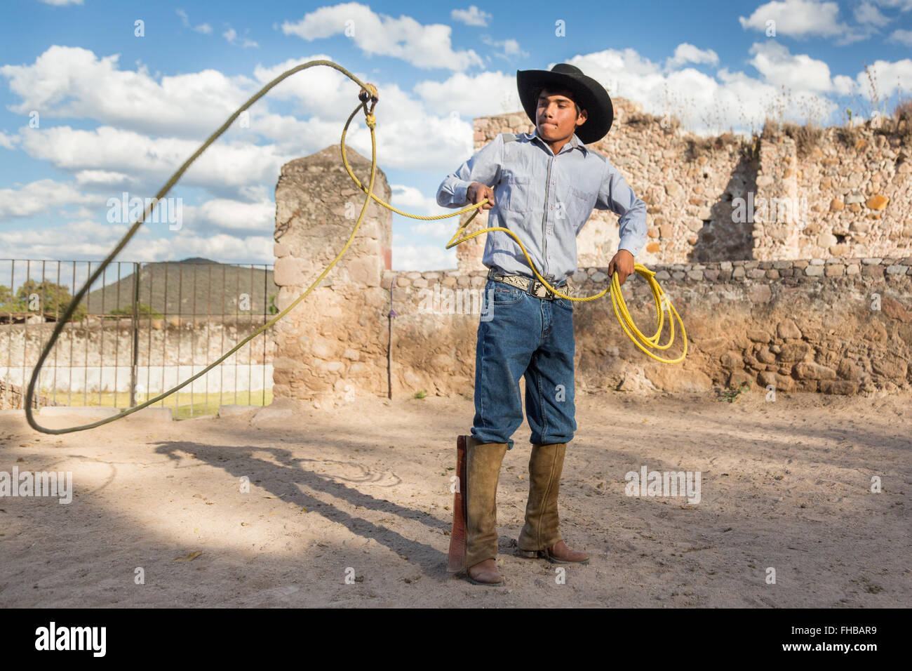 A Mexican charro or cowboy practices roping skills at a hacienda ranch ...