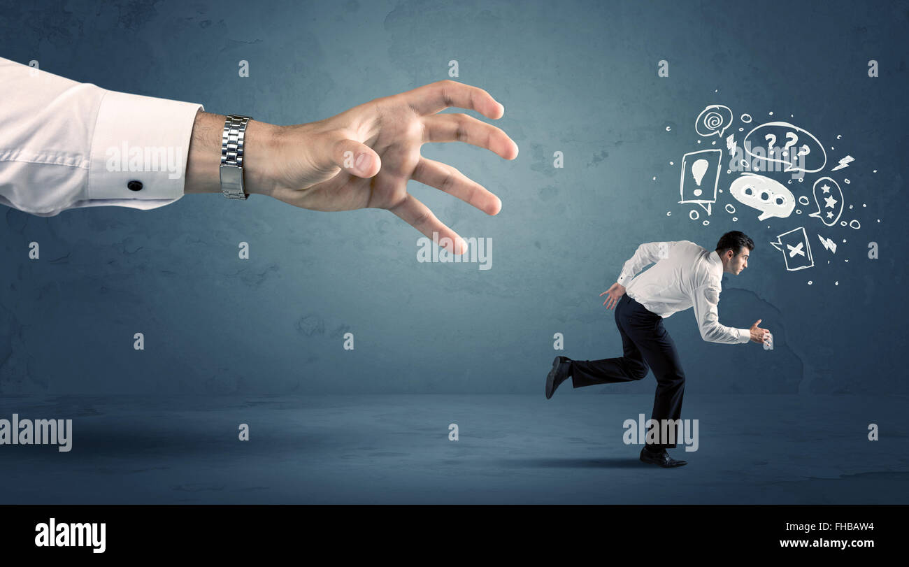 Business man running from a big hand Stock Photo - Alamy