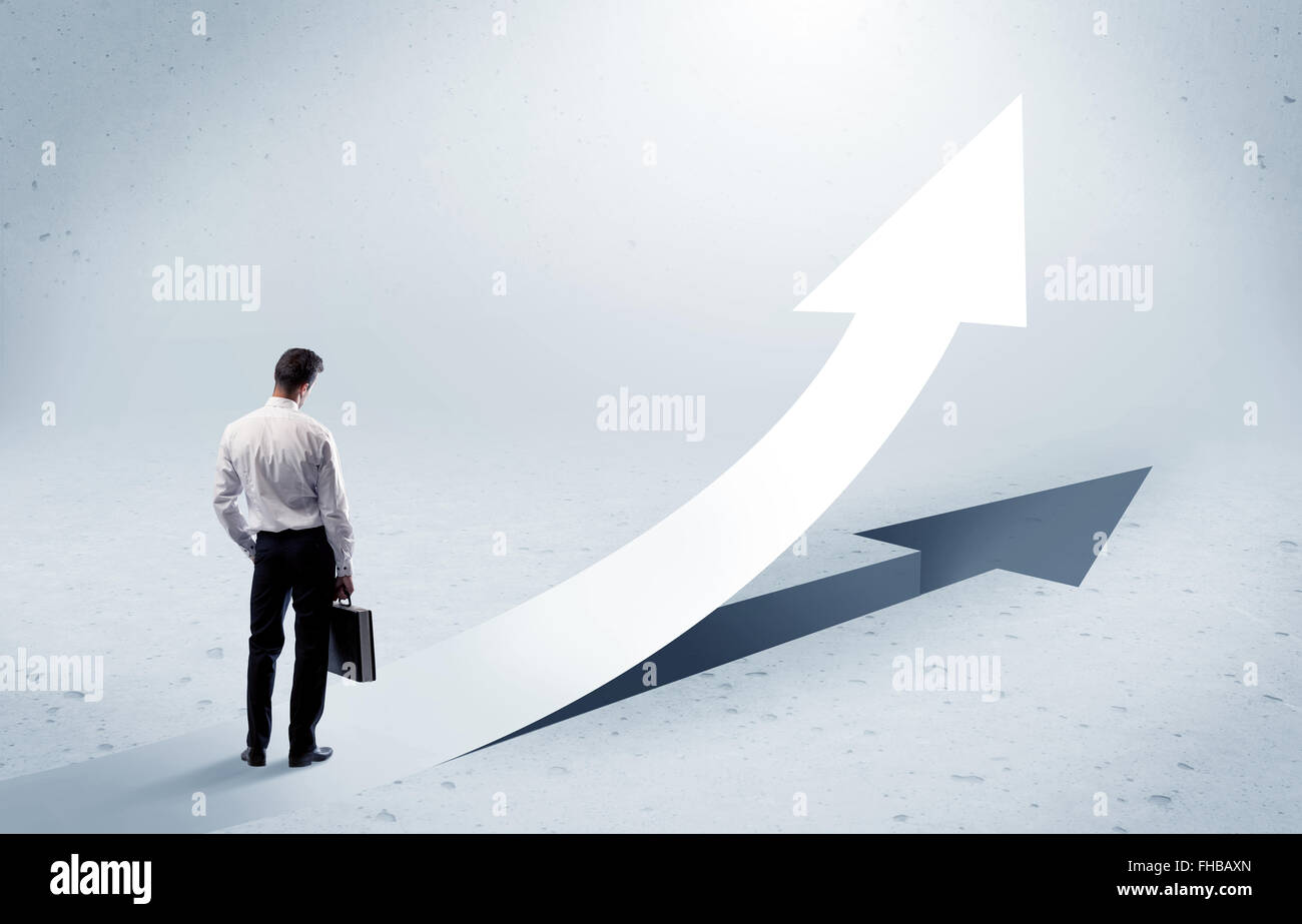 Arrow pointing up with standing salesman Stock Photo - Alamy