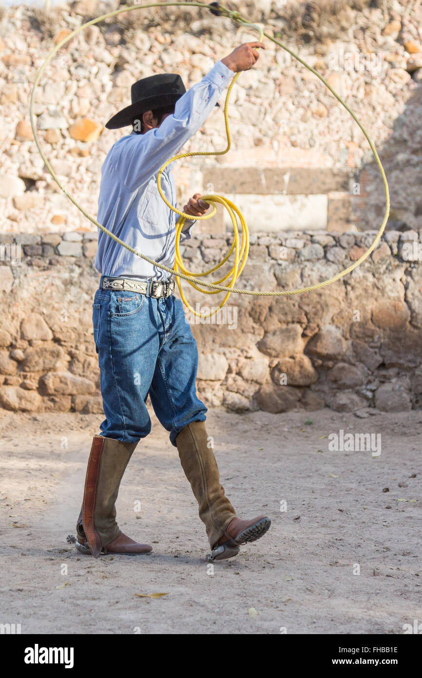 A Mexican charro or cowboy practices roping skills at a hacienda ranch ...