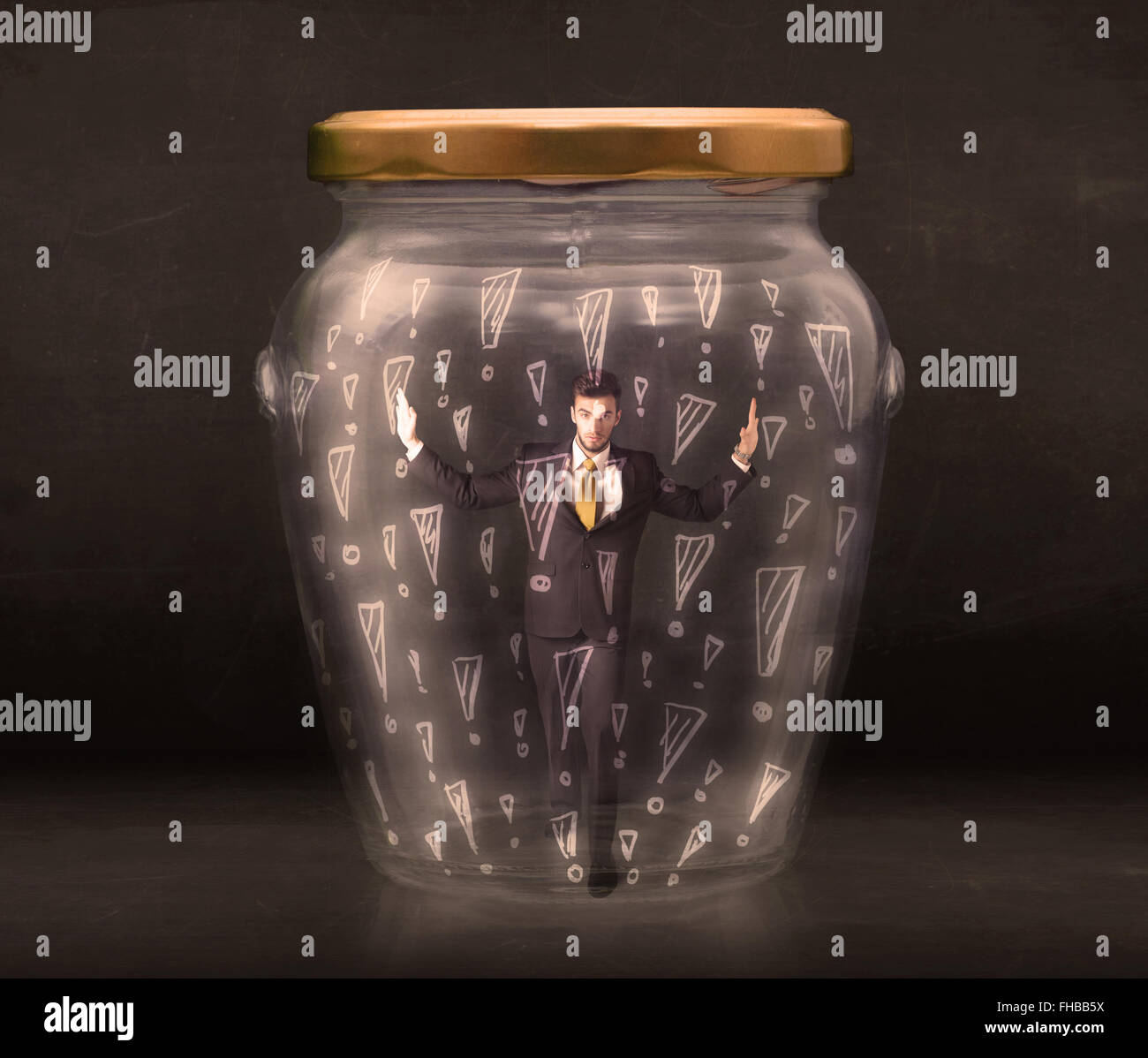 Business man trapped in jar with exclamation marks concept Stock Photo ...