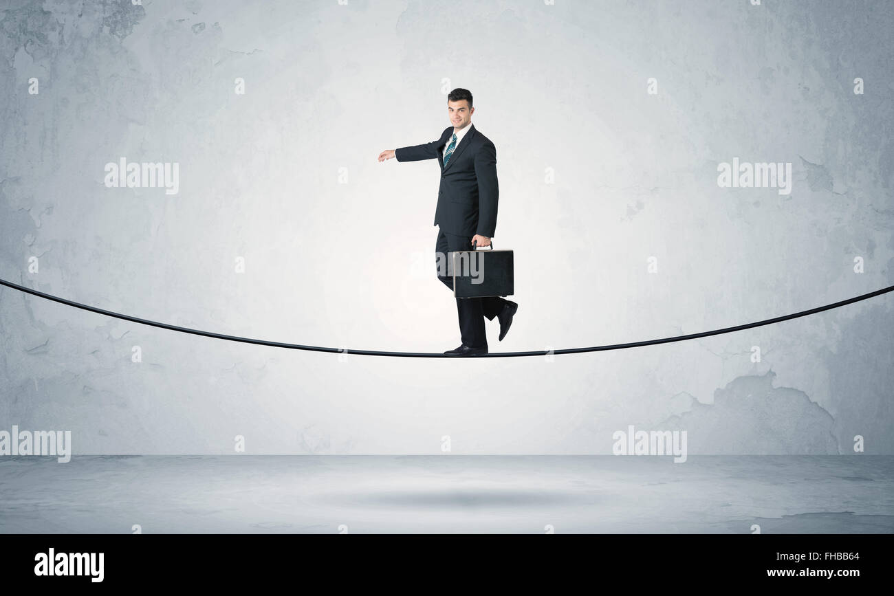 Sales guy balancing on tight rope Stock Photo - Alamy