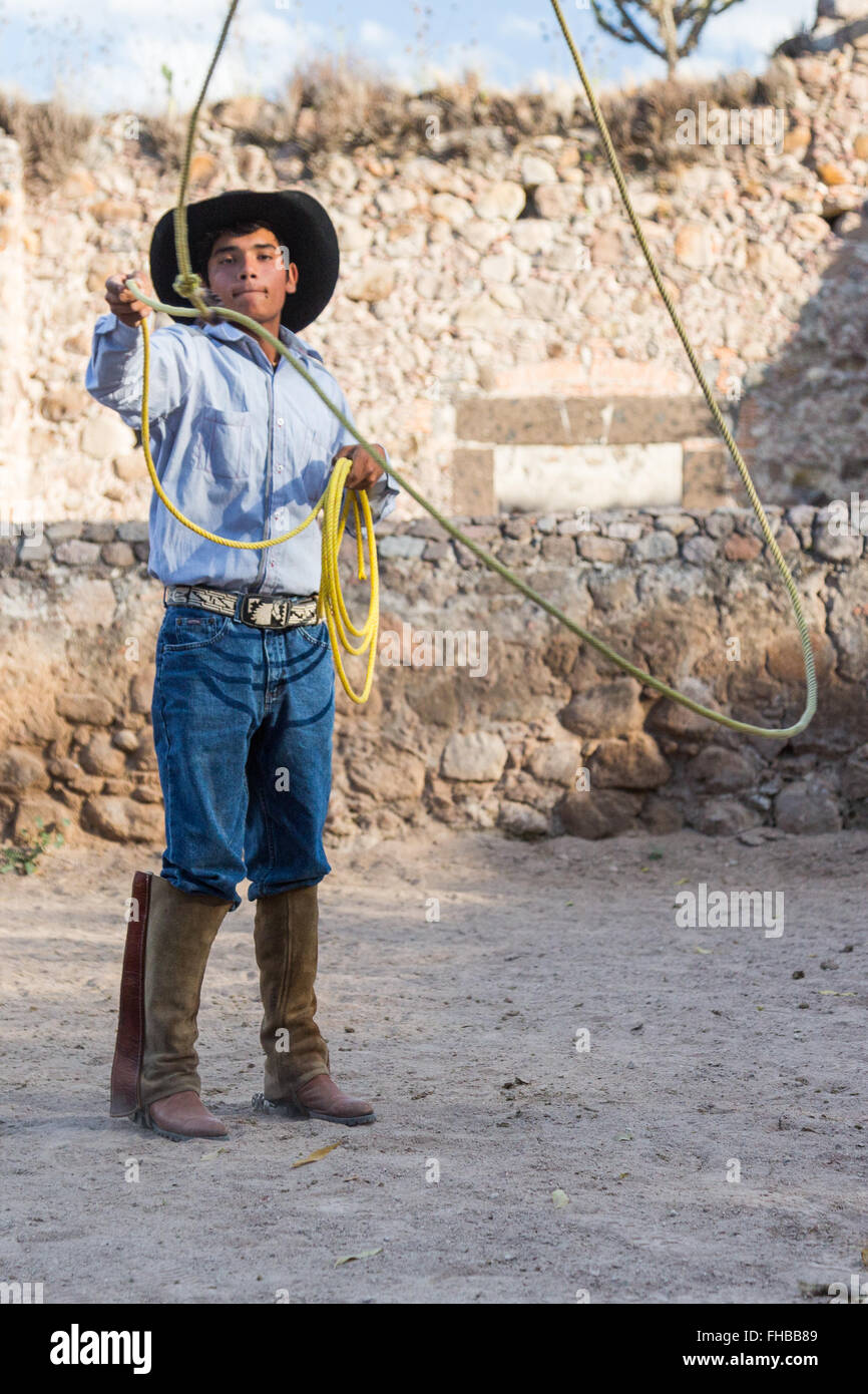 A Mexican charro or cowboy practices roping skills at a hacienda ranch ...