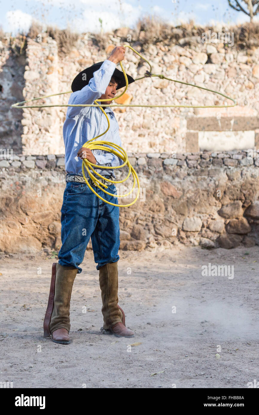 A Mexican charro or cowboy practices roping skills at a hacienda ranch ...