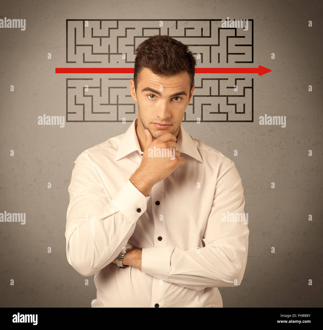 Handsome business guy solving maze Stock Photo - Alamy