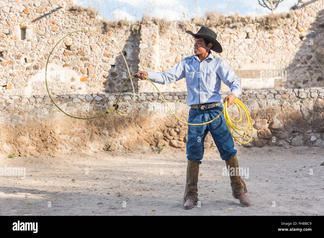 A Mexican charro or cowboy practices roping skills at a hacienda ranch ...