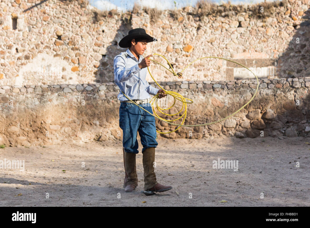 A Mexican charro or cowboy practices roping skills at a hacienda ranch ...
