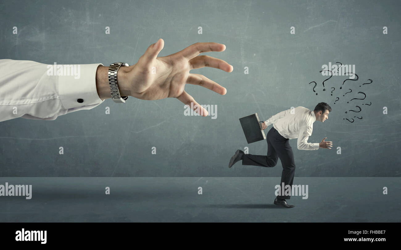 Businessman running away from a big hand Stock Photo - Alamy
