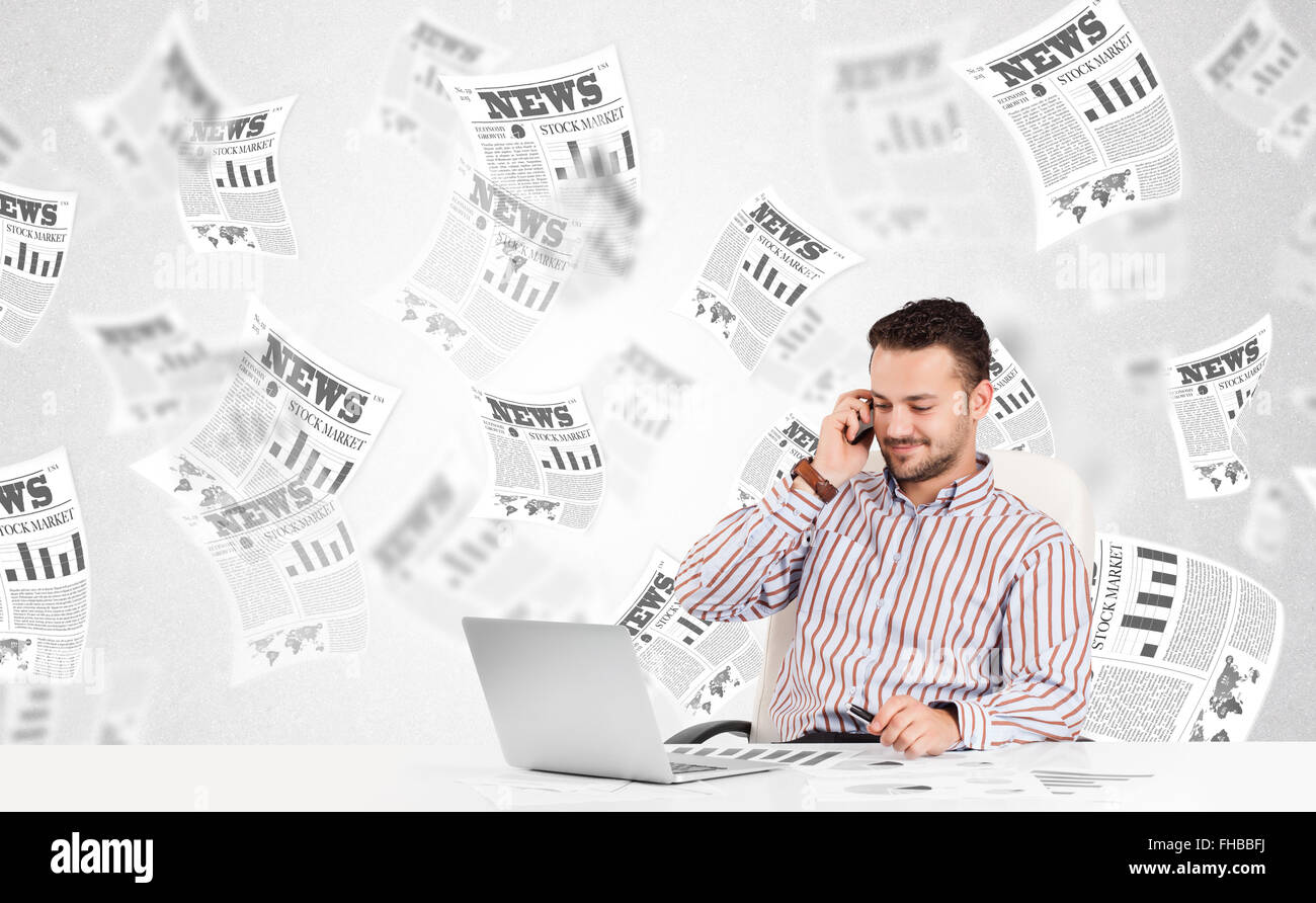 Business man at desk with stock market newspapers Stock Photo - Alamy